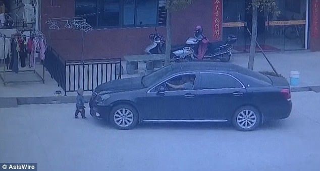 The car runs over him and puts him under the wheels, the little boy ...