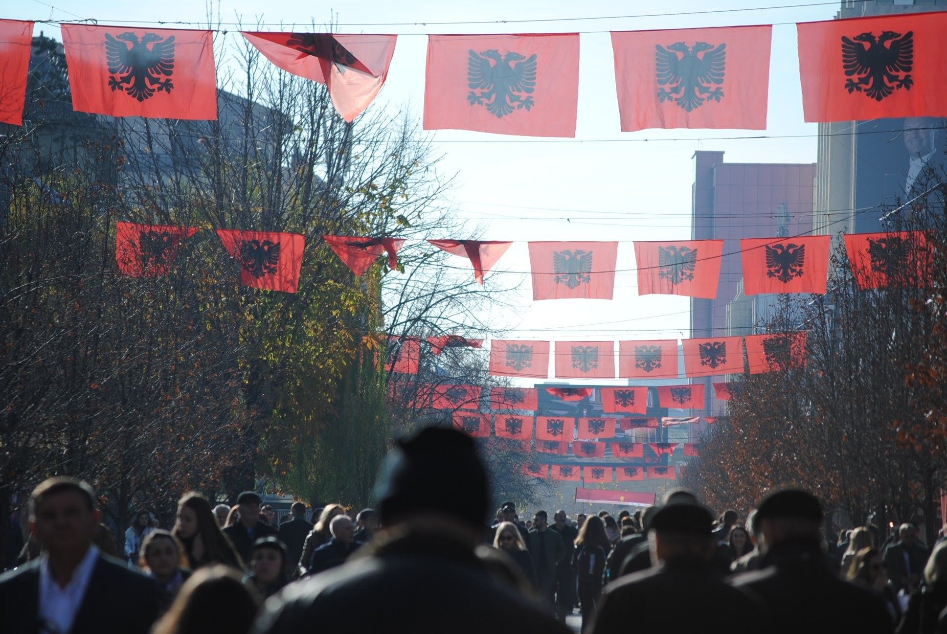 The square of Pristina is decorated with red and black flags ...