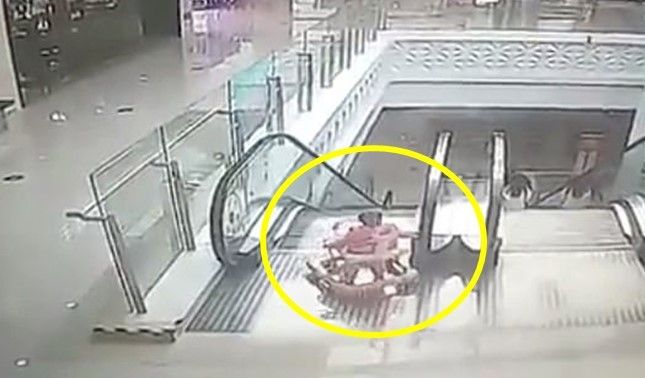 The baby in the stroller starts to "slide" down the escalator in a ...