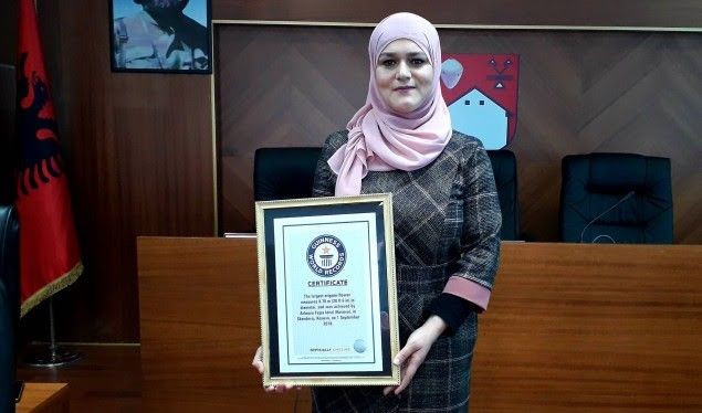 Arbnora Fejza-Idrizi receives the certificate from the staff of the ...
