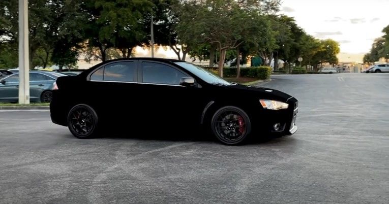 This is possibly the "blackest" car you'll ever see on the road ...