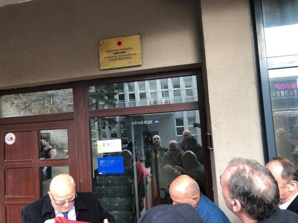 The plaque of the KLA base is revealed at the entrance of the building ...