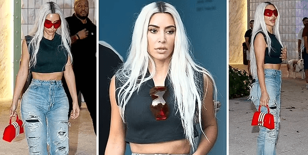 Kim Kardashian shows off her toned lines in a crop top and ripped jeans ...