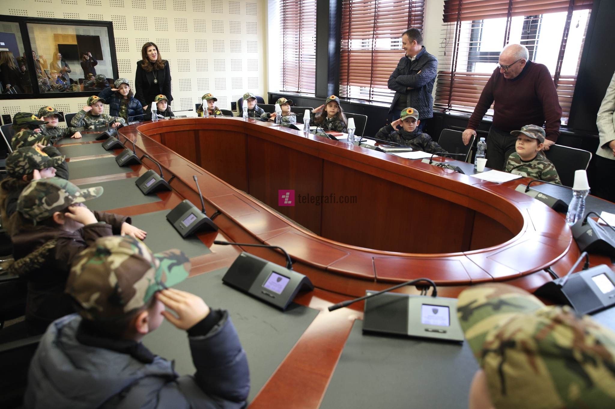 In military uniforms and with KLA emblems, students from Drenas visit ...