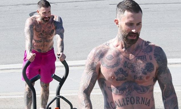Adam Levine shows off his tattooed body during an outdoor workout ...