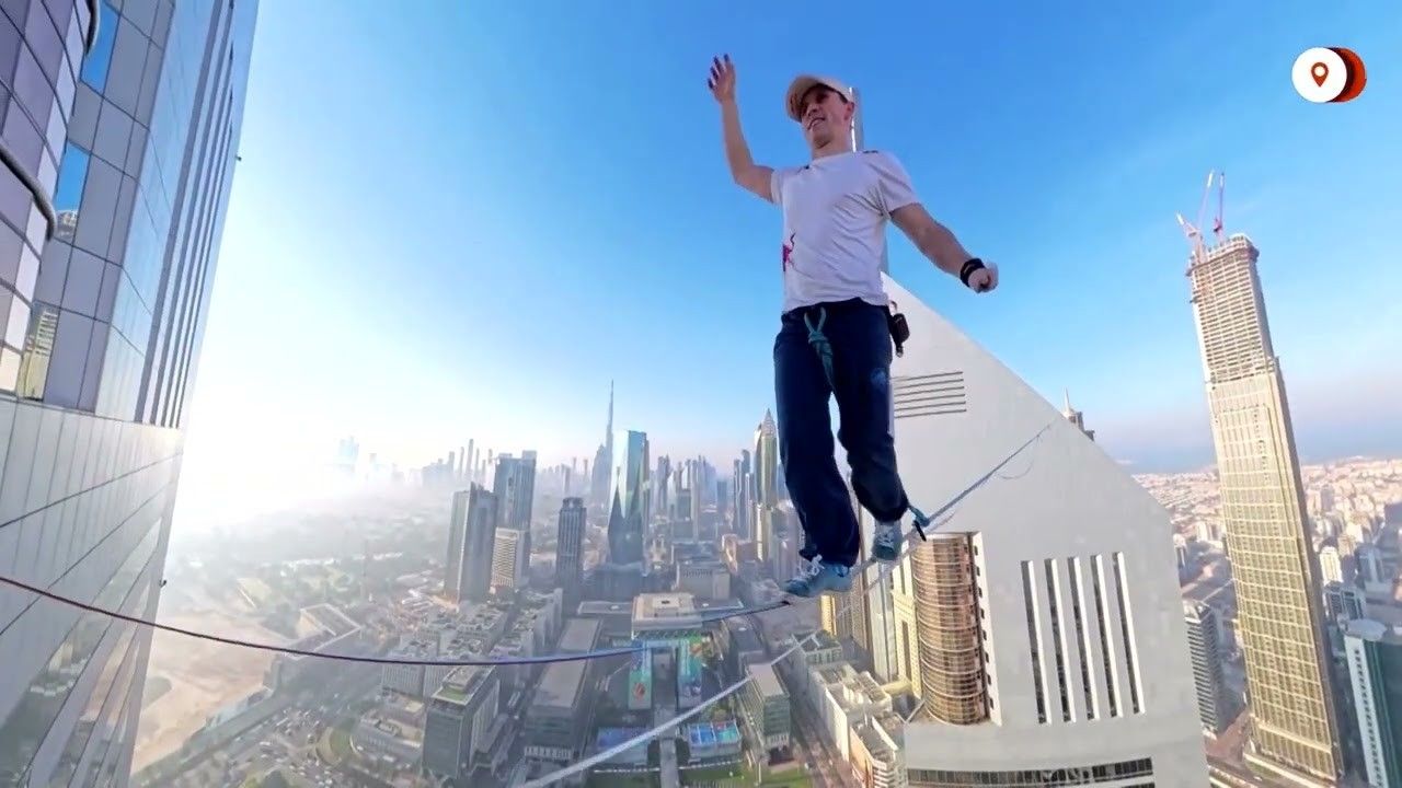 Estonian walks on a cable connected between two towers in Dubai at a ...